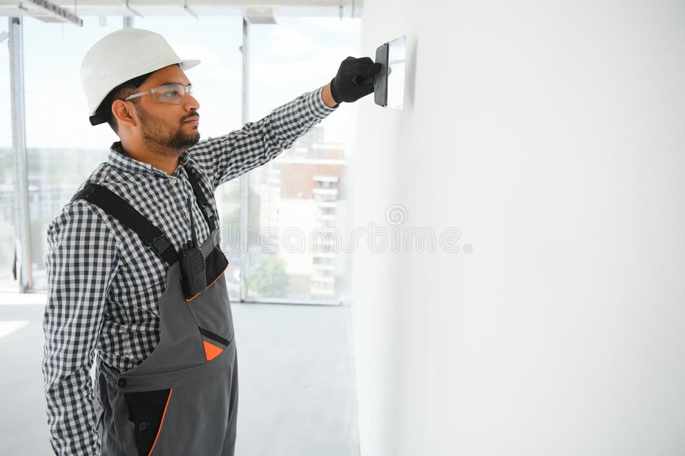 Renovation at Home. Indian Plasterer Spreading Plaster on Wall. Stock ...