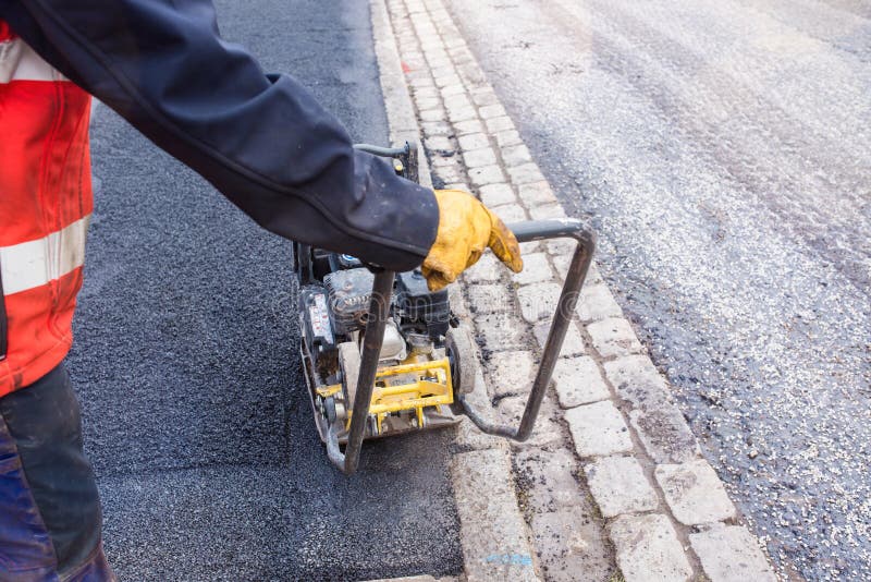 Road Worker Using Vibrating Compactor Close Up Stock Photo - Image of ...