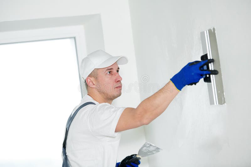 Refurbishment. Worker Spackling a Wall with Putty Stock Image - Image ...