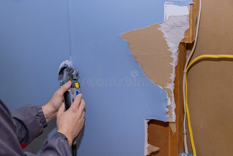 Renovation Service Work in the House Cutting Off Damaged Plasterboard ...