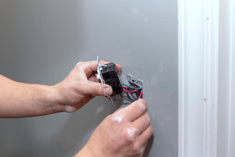 During Renovations, Professional Electrician Connects an Electric ...