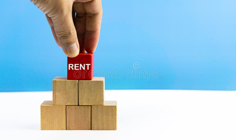 RENT Word on Red Wood Cube Block Stack with Blue Background Stock Photo ...