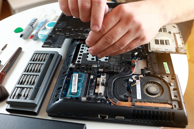 Repaiman with Screwdriver Fixing Disassembled Laptop Parts. Technical ...