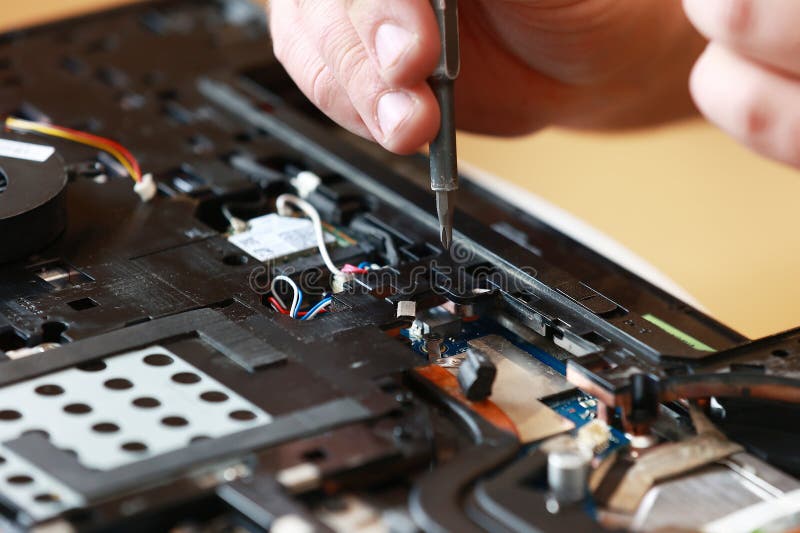 Repaiman with Screwdriver Fixing Disassembled Laptop Parts. Technical ...