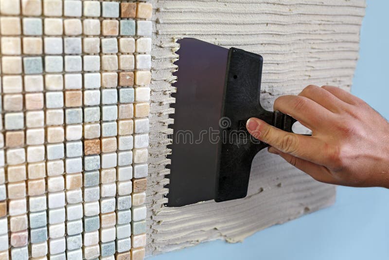 Repair in the Apartment: Installing the Mosaic Tile on the Wall Stock ...