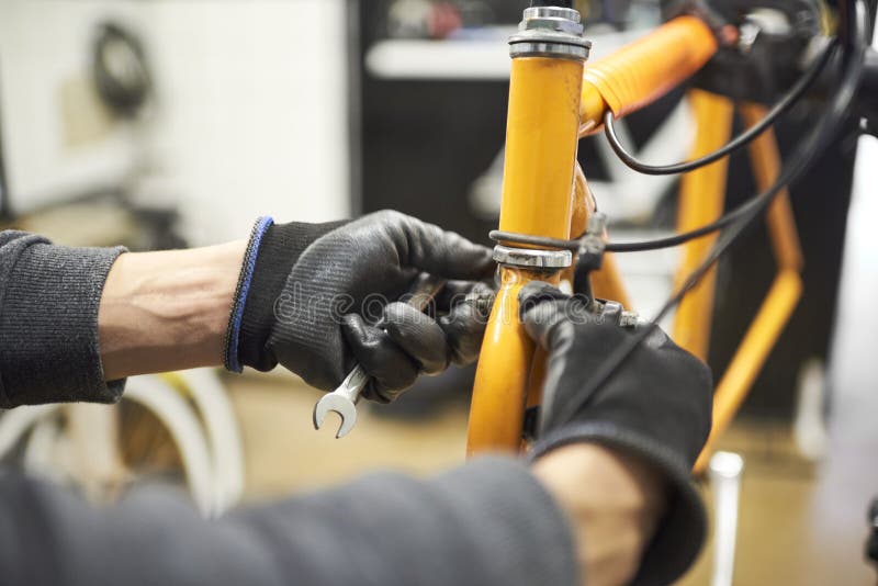 Repair of a Bicycle: Person Disassembling an Orange Bike in His ...
