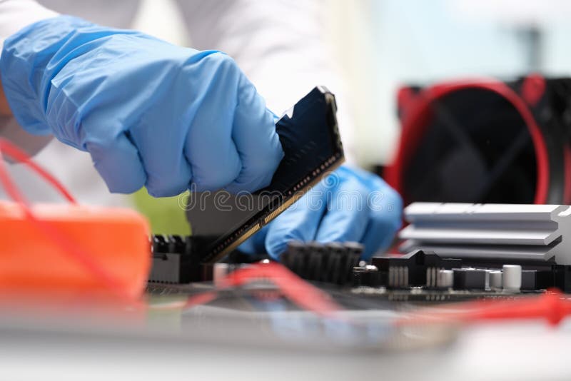 Repair Engineer Holds RAM Chip with Hands and Inserts RAM of Computer ...