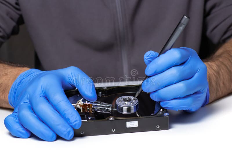 Repair Hard Disk. Hands of Master in Gloves with Screwdriver Repair the ...