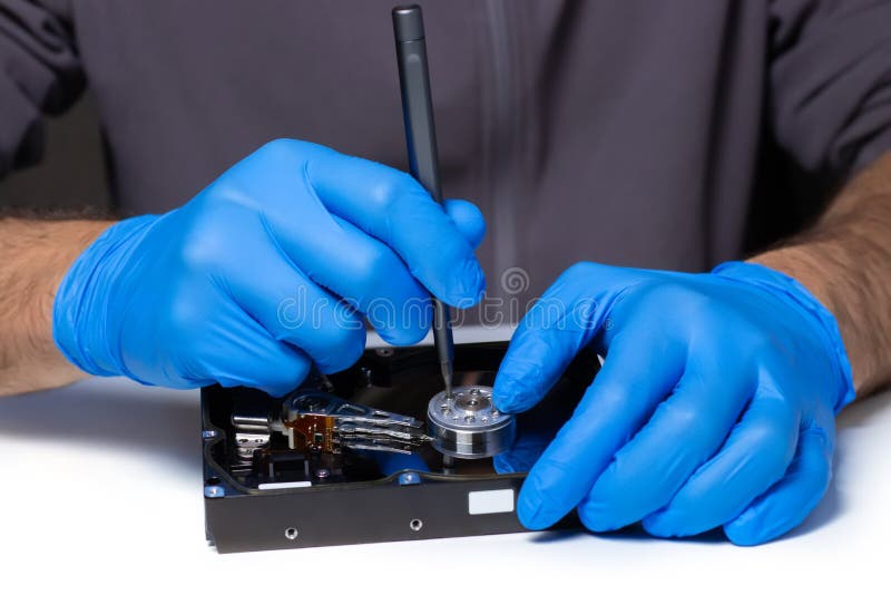 Repair Hard Disk. Hands of Master in Gloves with Screwdriver Repair the ...