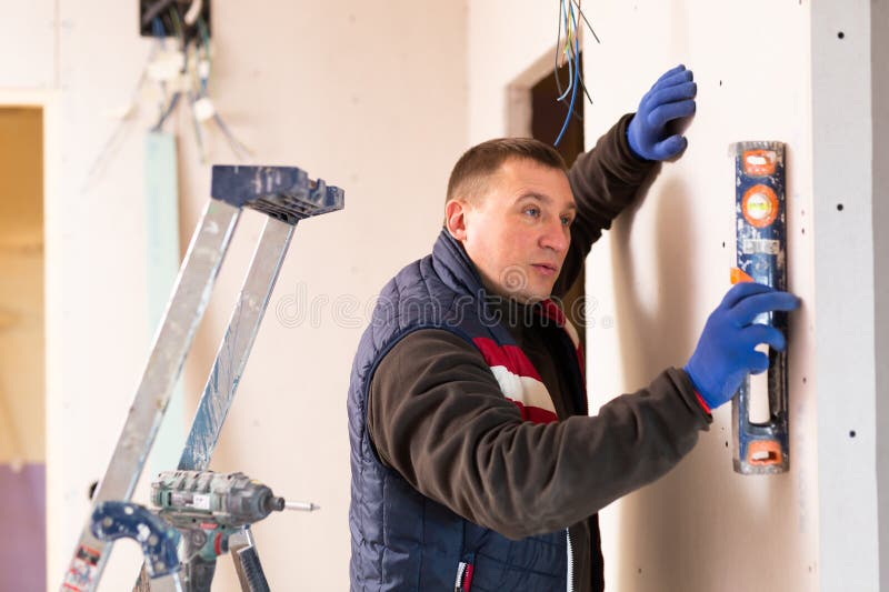 Repair Man Measuring Evenness of Wall Stock Photo - Image of measuring ...