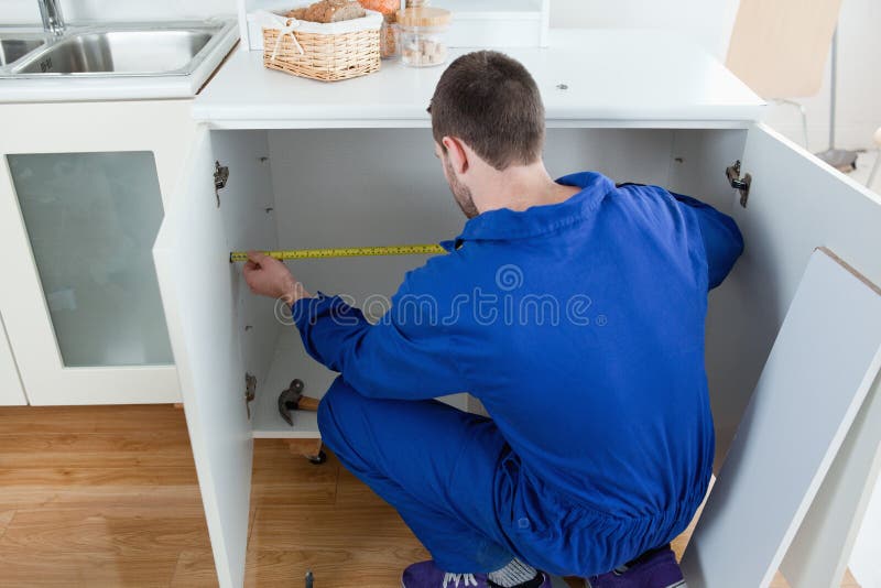 Repair Man Measuring Something Stock Photo - Image of kitchen, blue ...