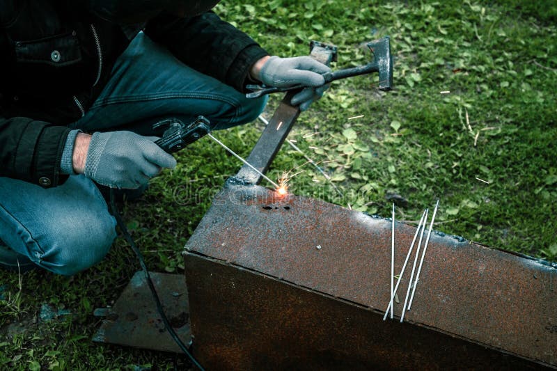 Repair of Metal Objects. a Master Welder Welds an Old Iron Structure ...