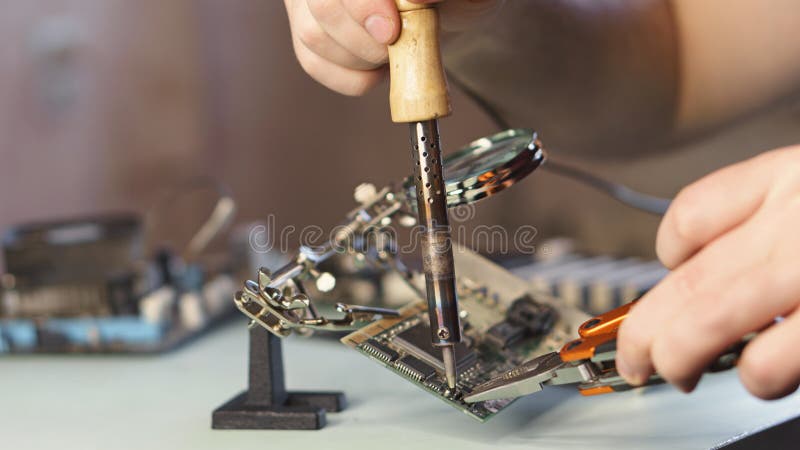 Repair of a PC Motherboard with a Screwdriver with a Red Handle Stock ...