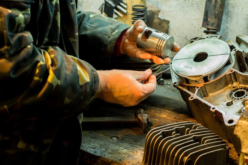 Repair of Motorcycle Engine in the Garage Stock Image - Image of arms ...