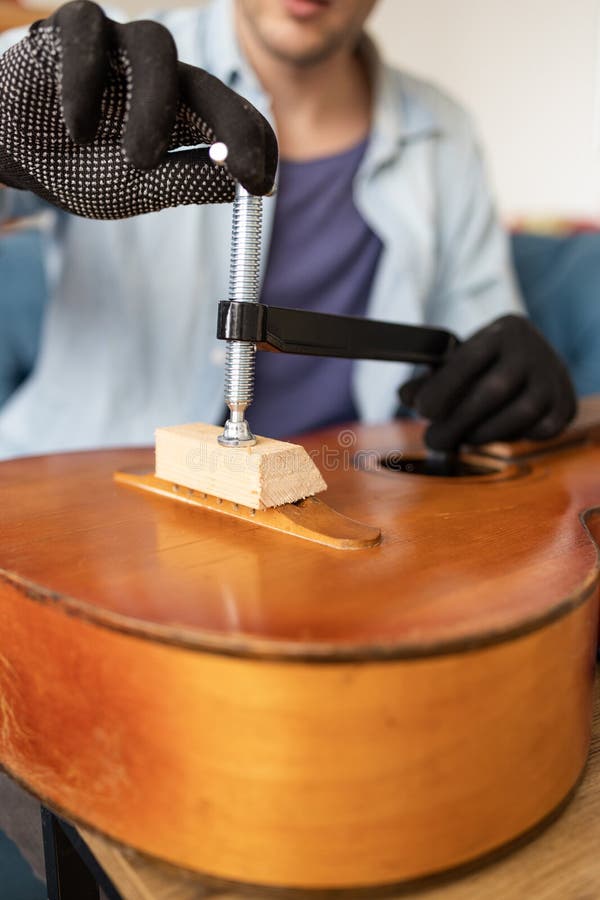 Restring Classical Guitar Concept. the Man Repair an Old Guitar. Stock ...