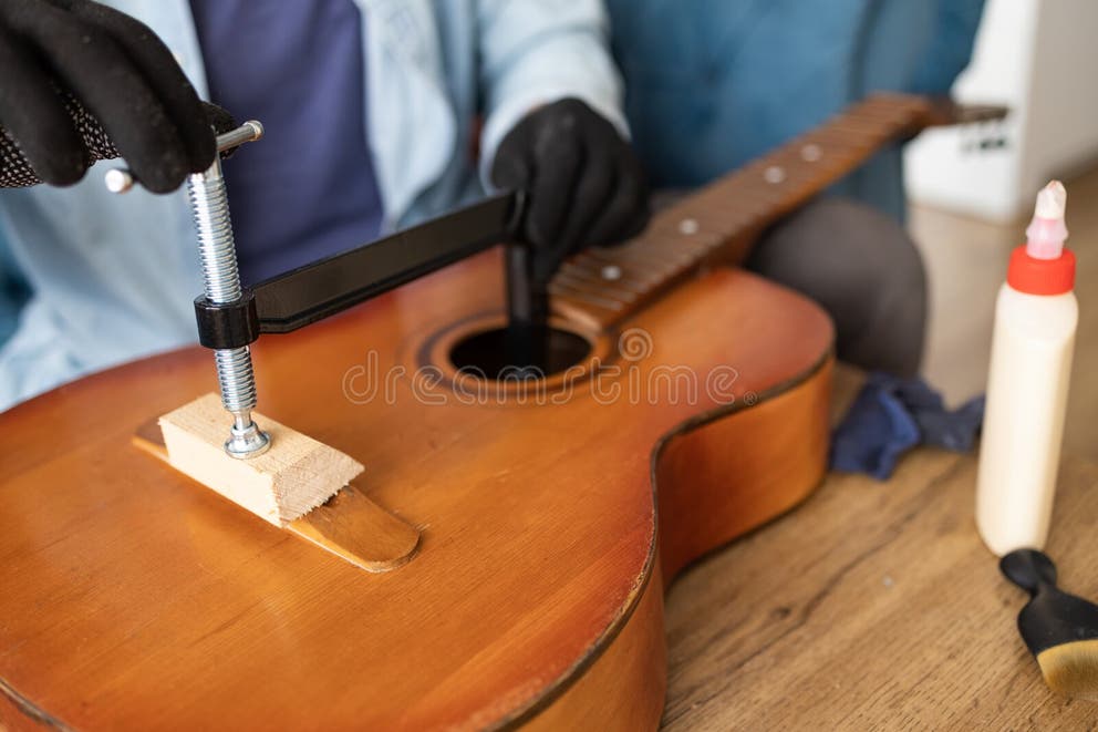 Restring Classical Guitar Concept. the Man Repair an Old Guitar. Stock ...