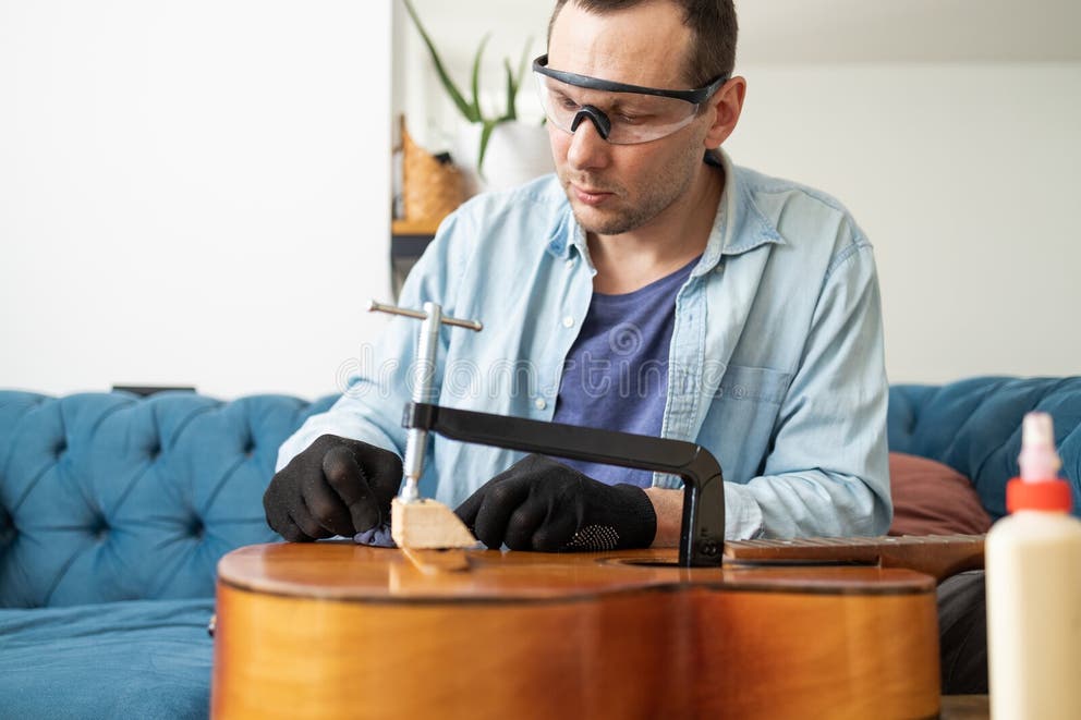 Restring Classical Guitar Concept. the Man Repair an Old Guitar. Stock ...