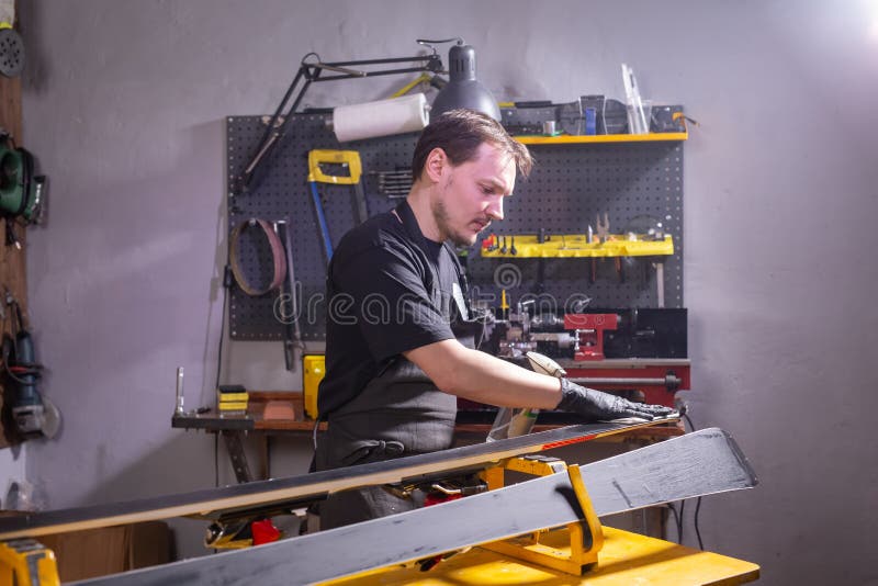 Repair, People Concept - Mechanic, Man is Rubbing a Ski Stock Photo ...