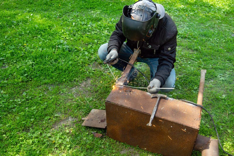 Repair and Restoration of Metal Objects. a Master Welder Welds an Old ...