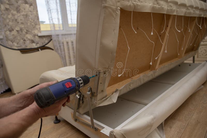 Repair the Sofa. Diy. Unscrews the with a Screwdriver. Stock Image ...