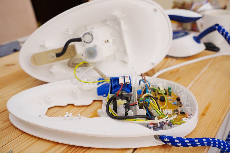 Repair of a steam iron. stock photo. Image of repair - 347497184