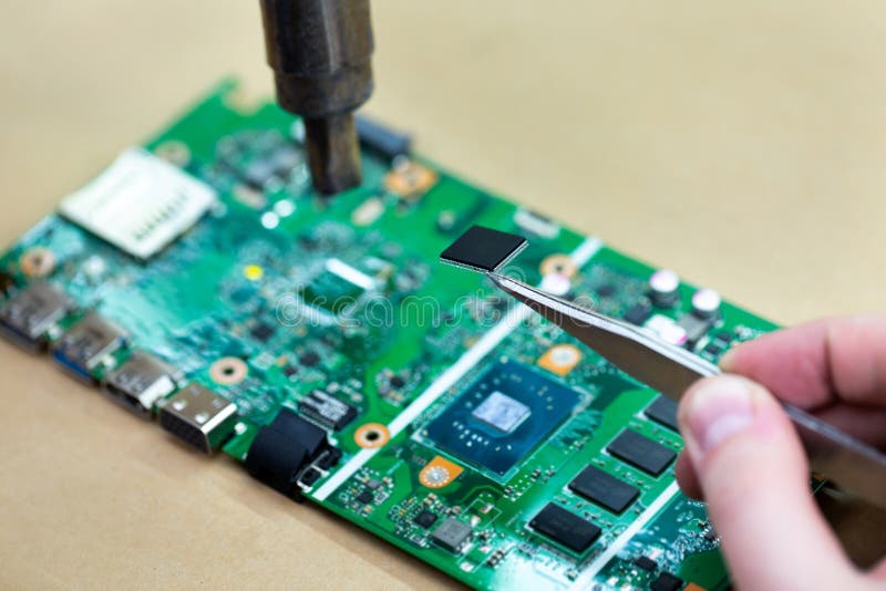 Repairing a Computer Chip with a Soldering Iron. Stock Image - Image of ...