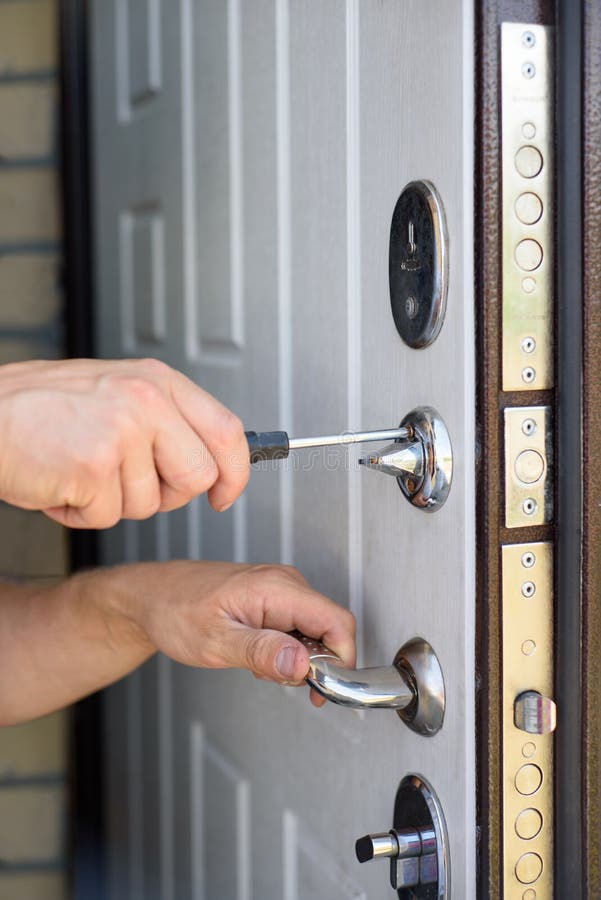Repairing the Door Lock with a Screwdriver. Stock Image - Image of ...