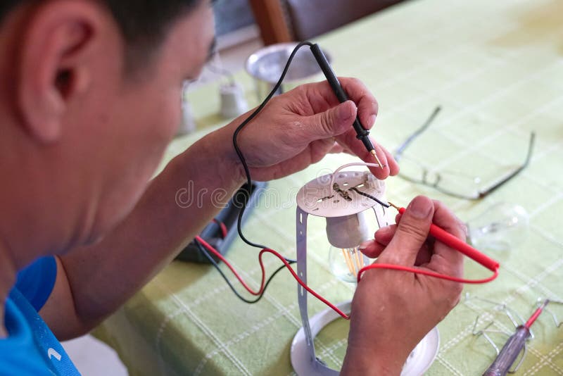 Repairing Light Bulb by Checking Voltage at the Electrical Terminal ...