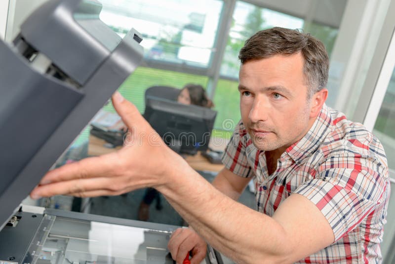 Repairing printer at work stock image. Image of male - 89032883
