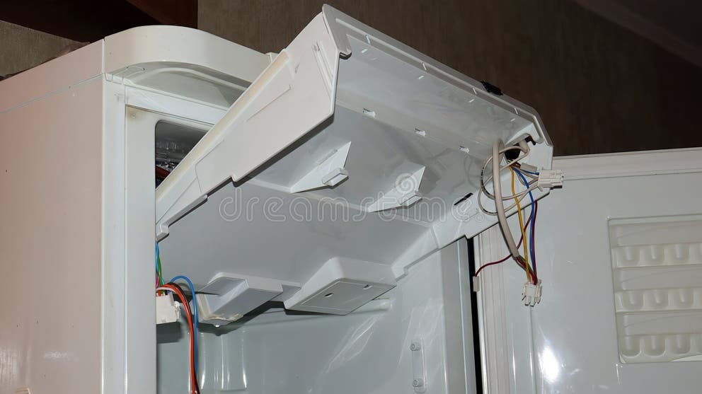 Refrigerator Repair Work in a Kitchen Shows Dismantled Parts and ...