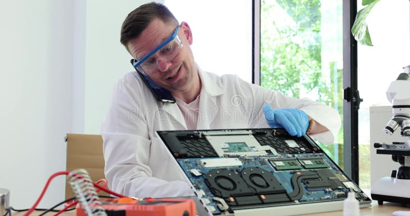 Repairing and Testing Computer Equipment and Male Engineer Talking on ...