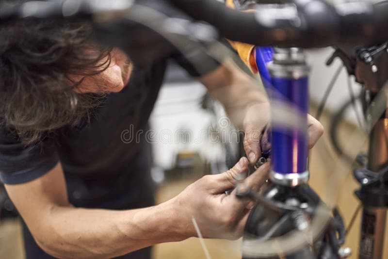 Man Assembling the Braking and Shifting System of a Bicycle at His ...