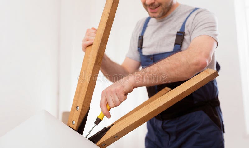 Repairman Assembling Table Using Screwdriver Working Standing Indoors ...