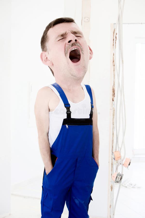 Repairman with Big Head in a Boilersuit is Yawning Stock Image - Image ...