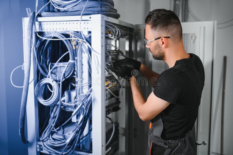 Repairman is Busy and Working with Internet Equipment and Wires in ...