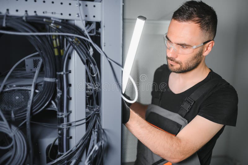 Repairman is Busy and Working with Internet Equipment and Wires in ...