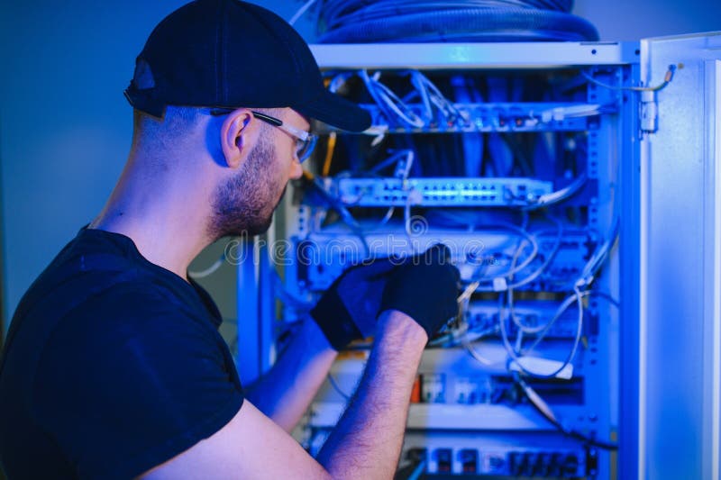 Repairman is Busy and Working with Internet Equipment and Wires in ...
