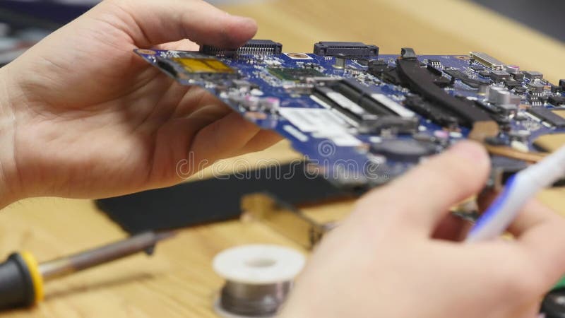 Repairman Disassembling Laptop Motherboard. Engineer Fixing Broken ...