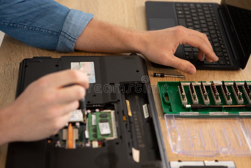 Repairman Disassembling Laptop Motherboard with Tools Stock Image ... Repairman Disassembling Laptop Motherboard with Tools Stock Image ...