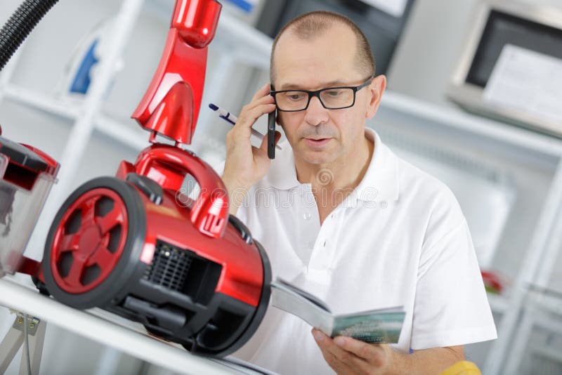 Repairman Fixing Vacuum Cleaner Stock Image - Image of living, remote ...