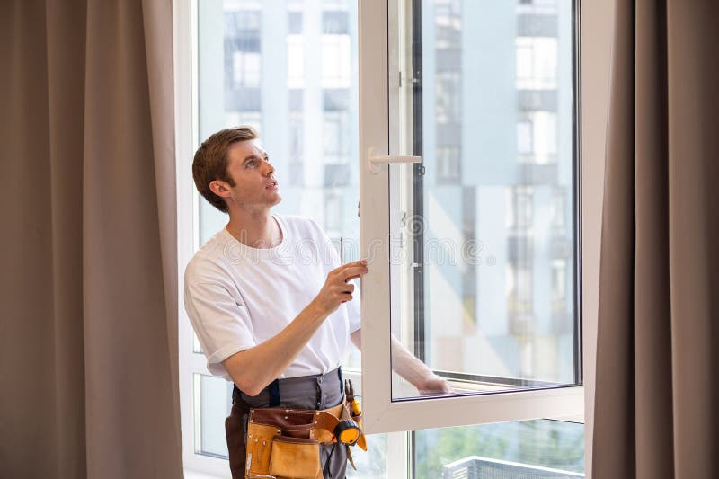 A Repairman Fixing Windows in New Apartment Stock Photo - Image of ...