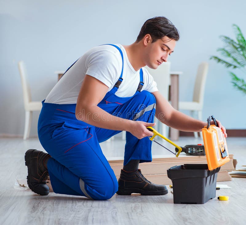 Repairman Laying Laminate Flooring at Home Stock Image - Image of male ...