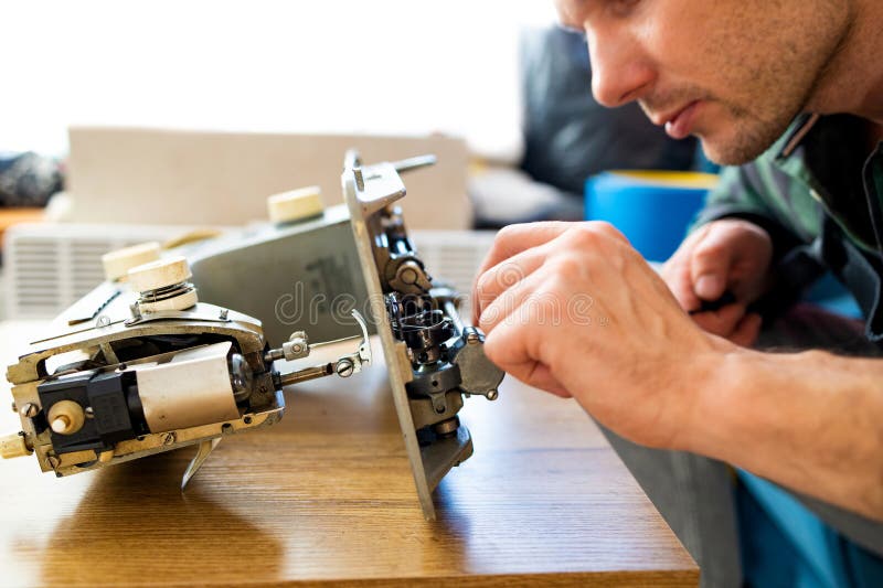 Repairman Master is Testing Old Disassembles Sewing Machine in Workshop ...