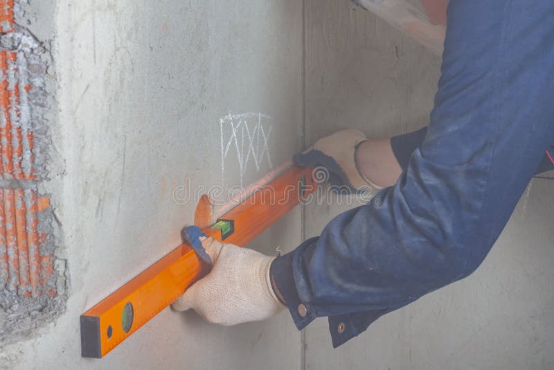 The Repairman Measures the Horizontal and Vertical Level with the Tool ...