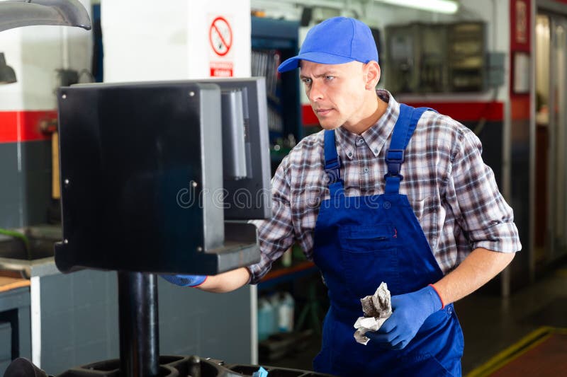 Repairman Mechanic at Wheel Balancing Using Computer Stock Photo ...