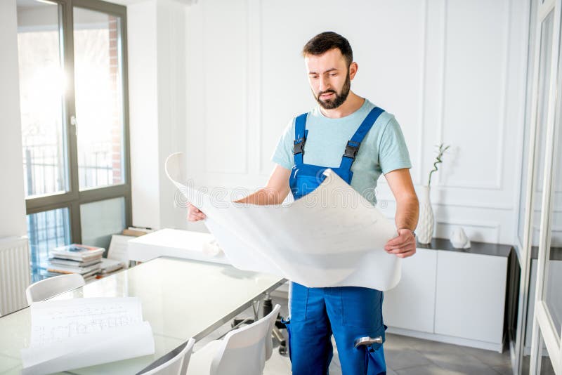 Repairman with Paper Drawings at the Office Stock Image - Image of ...