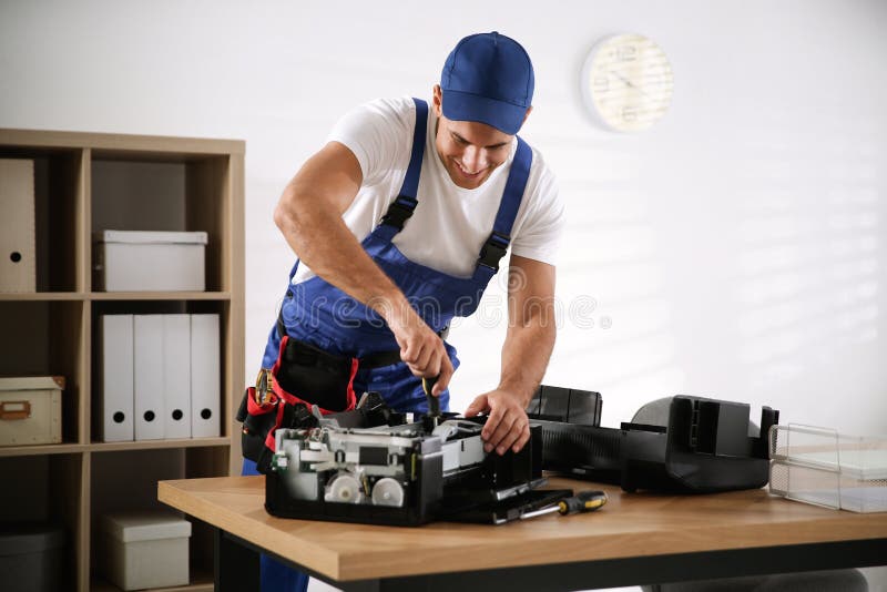 Repairman with Screwdriver Fixing Modern Printer in Office Stock Photo ...