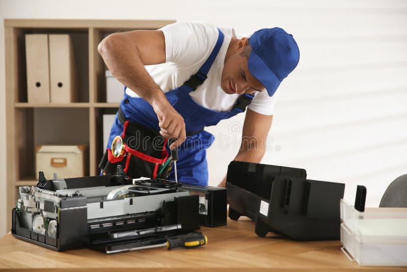 Repairman with Screwdriver Fixing Modern Printer in Office Stock Photo ...