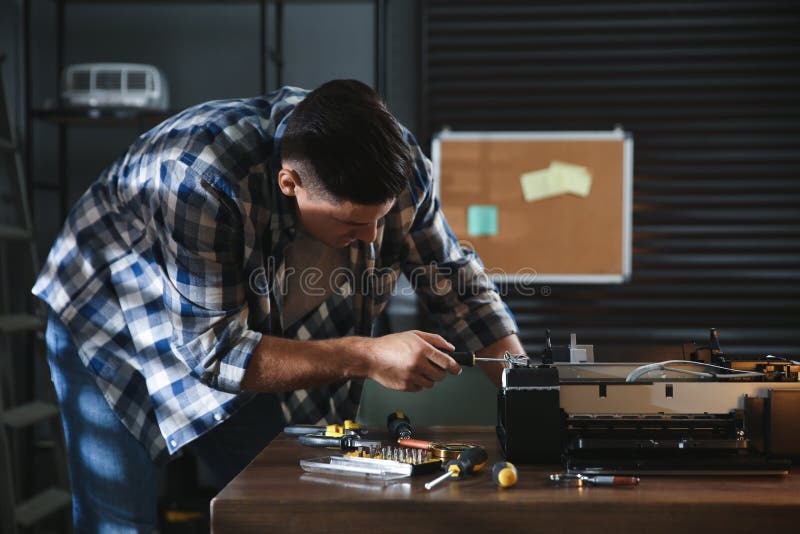Repairman with Screwdriver Fixing Modern Printer in Office Stock Image ...
