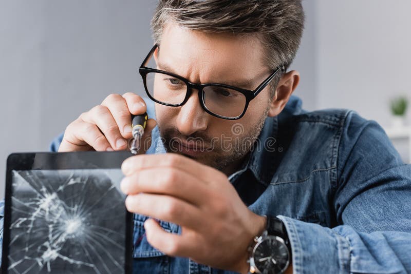 Repairman with Screwdriver Fixing Smashed Display Stock Image - Image ...